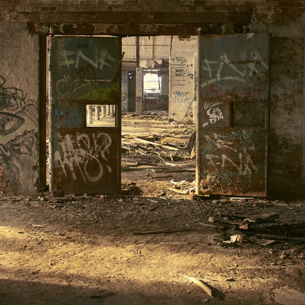 Rusted iron doors in an abandoned half demolished factory in Leipzig ...